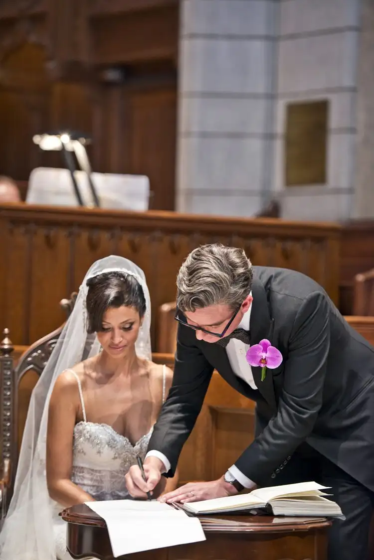 Bride and Groom Sign Marriage License